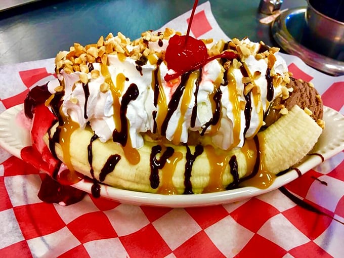 This banana split isn't just dessert—it's a childhood memory served in a dish, with enough toppings to make your dentist buy a vacation home.