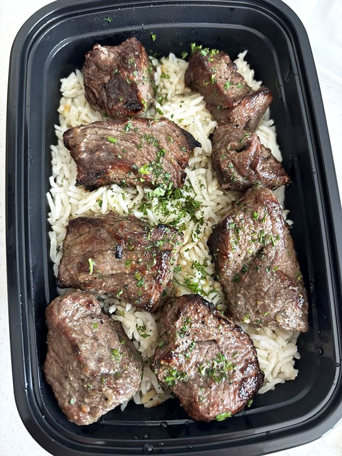 Beef kabobs lounging on a bed of rice like they own the place – and with flavor this bold, they absolutely do.