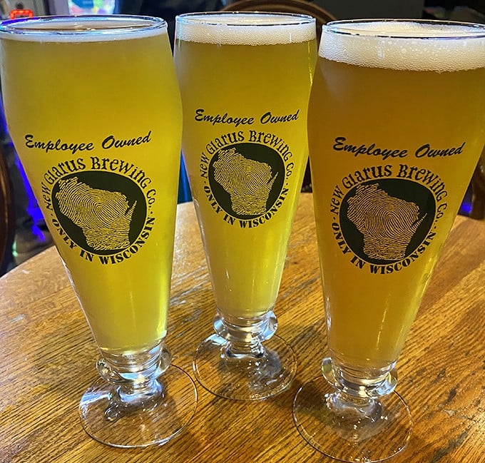Three golden glasses of New Glarus beer—because in Wisconsin, "hydration" is just a fancy word for "another round, please."
