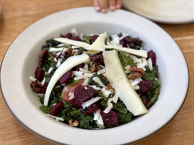 A beet salad that could convert even the most dedicated carnivore—earthy jewels crowned with shaved cheese and tossed with greens.