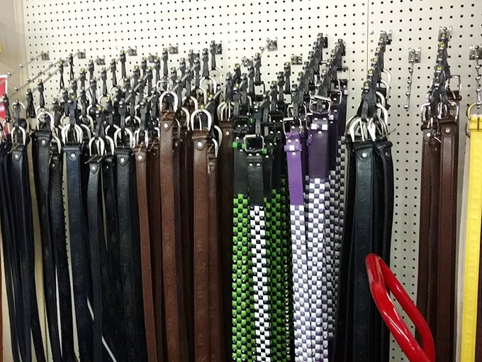 Leather belts hanging like patient sentinels. Some checkered, some plain, all waiting for the perfect pair of pants to rescue.
