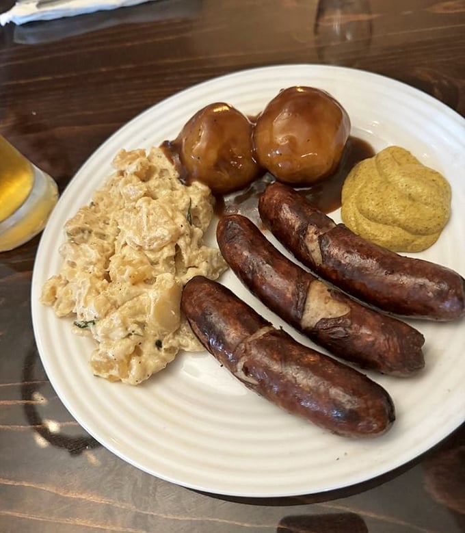 These bratwursts have that perfect snap when you cut into them, nestled alongside potato salad that deserves its own fan club.
