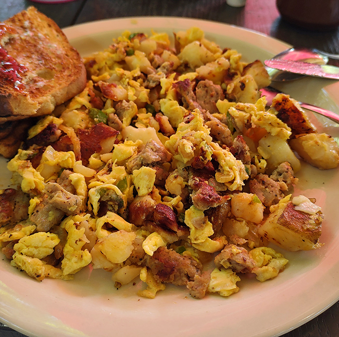 This breakfast scramble contains more delicious ingredients than most people's weekly grocery list – a beautiful chaos of eggs, potatoes, and savory treasures.