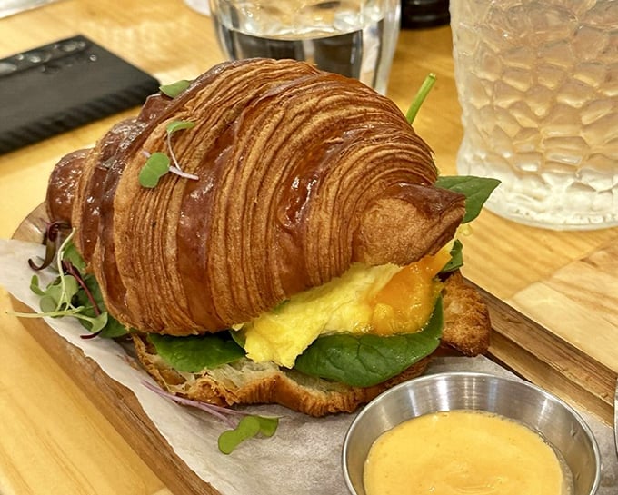 A breakfast croissant sandwich that makes you wonder why we ever settled for English muffins—flaky, buttery, and unapologetically indulgent.