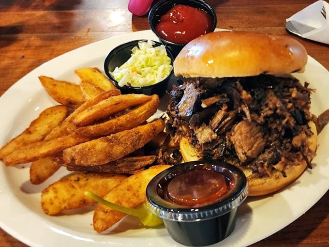 This pulled pork sandwich isn't messing around – it's bringing smoky, tender meat, crispy fries, and the kind of satisfaction money can't usually buy.