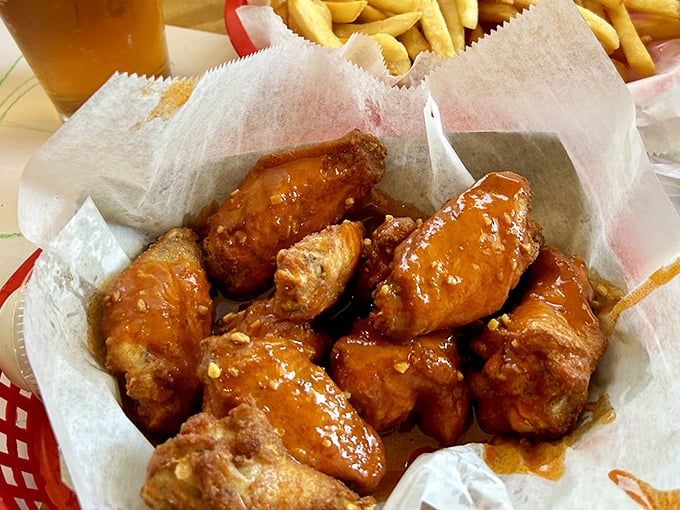 Buffalo wings glistening with sauce that promises a flavor explosion – these aren't just wings, they're little drums of joy playing a spicy symphony.