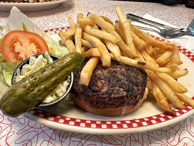A burger that commands respect—perfectly charred, properly dressed, and accompanied by fries that clearly graduated with honors.
