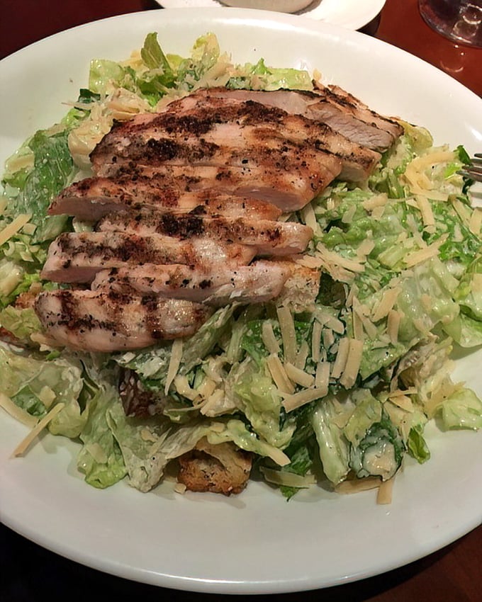 Caesar salad topped with grilled chicken—the dish that launched a thousand diets. Crisp romaine and savory protein in perfect harmony.