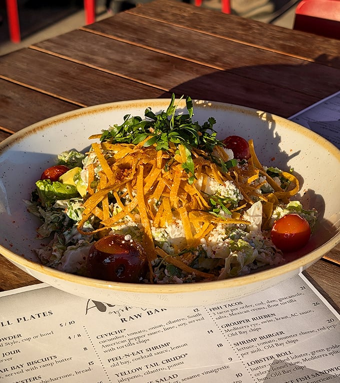 A salad that actually deserves to be ordered instead of just tolerated. Those shaved carrots on top aren't decoration—they're commitment to craft.