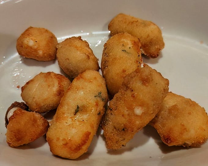 Cheese curds that don't squeak so much as sing—little golden nuggets of joy that disappear faster than your resolution not to overeat.