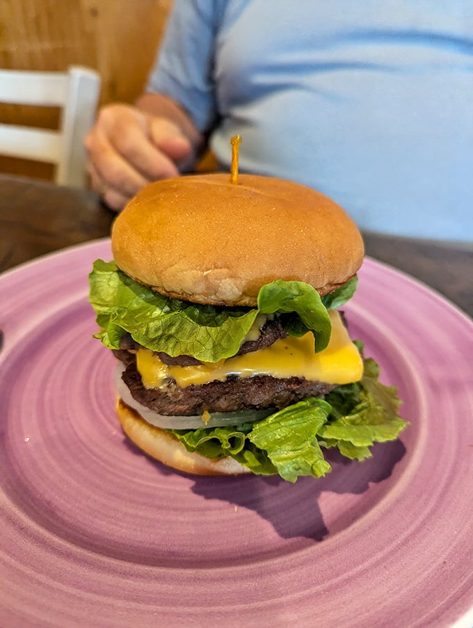 A burger that doesn't need gimmicks—just perfectly melted cheese, fresh lettuce, and a bun that knows its supporting role in this meaty production.