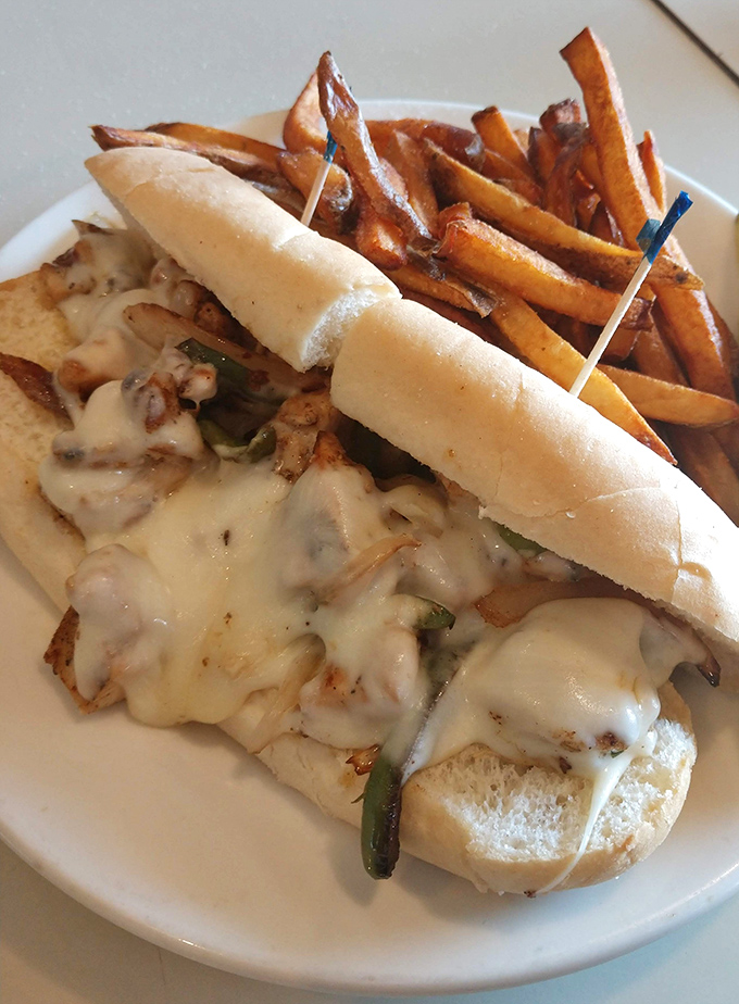 Melted cheese cascading over grilled chicken like a dairy waterfall. This sandwich doesn't just satisfy hunger—it performs culinary theater on your plate.