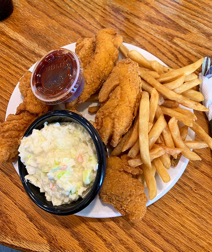 The chicken strip basket: proof that sometimes the simplest pleasures—perfectly breaded chicken, golden fries, and creamy coleslaw—are the most satisfying.