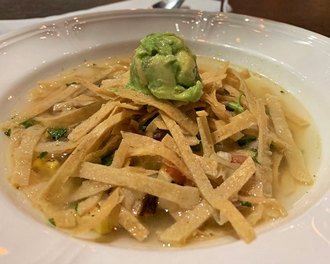 This isn't just soup – it's a Southwest vacation in a bowl, topped with crispy tortilla strips and a dollop of avocado bliss.