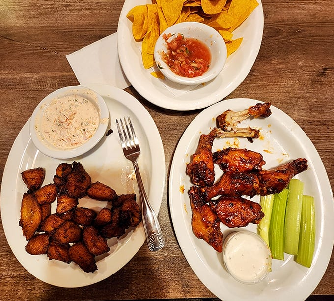 Crispy plantains, savory chicken wings, and homemade salsa – proof that sometimes the best meals are assembled from multiple small plates of joy.