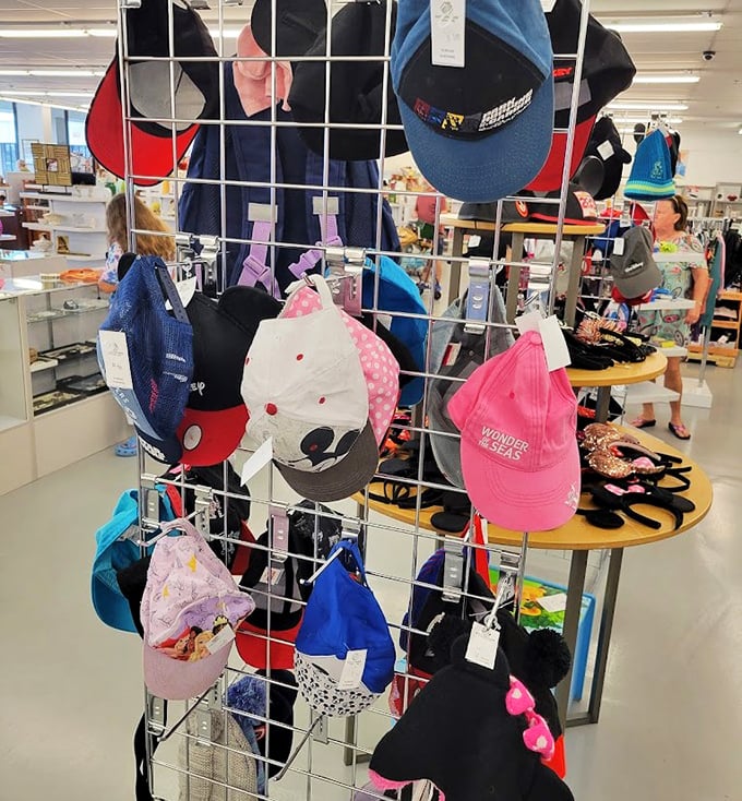 Hat heaven for the indecisive shopper—Mickey ears and baseball caps offering both shade and character at thrift store prices.