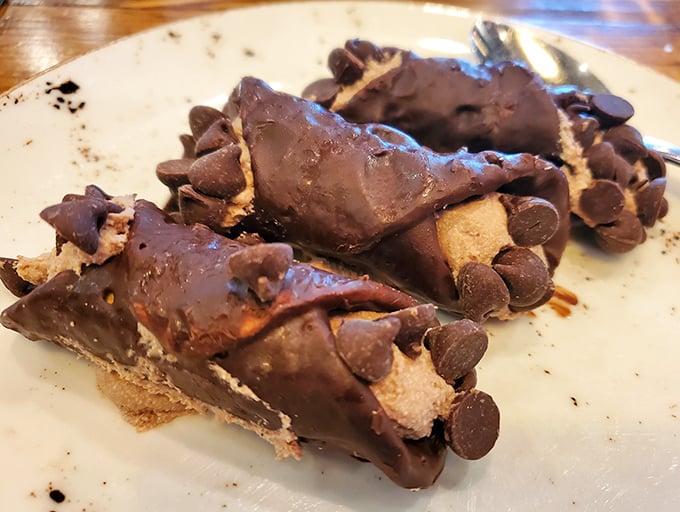 Chocolate cannoli that shatters with purpose, revealing a creamy interior studded with chocolate chips—Sicily's gift to your sweet tooth.