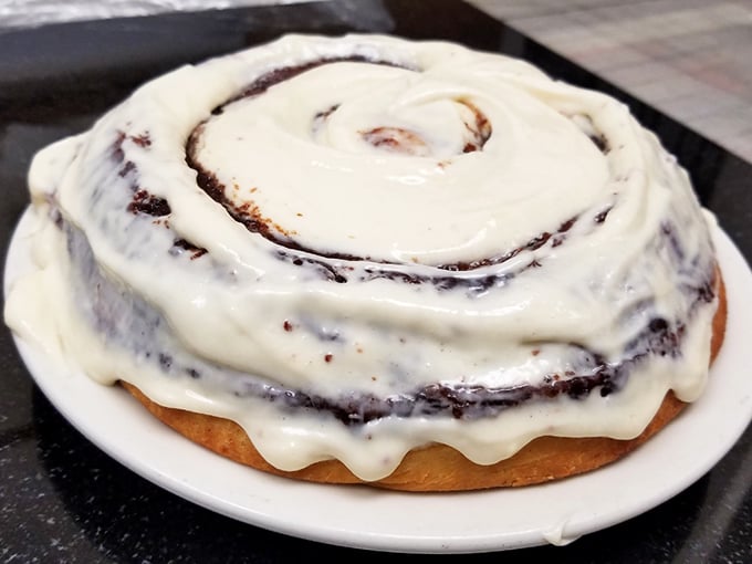 That cinnamon roll isn't just breakfast—it's a spiral galaxy of butter, sugar, and spice that makes you understand why people lined up for these before smartphones existed.
