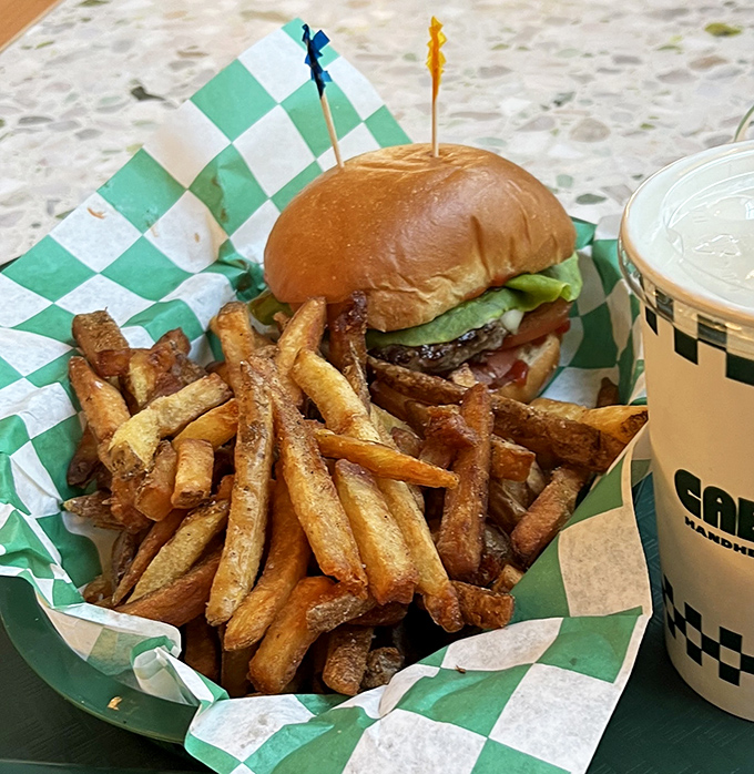 The classic burger and fries combo—proof that sometimes the simplest pleasures are the most profound. Those fries look like they were worth the trip alone.