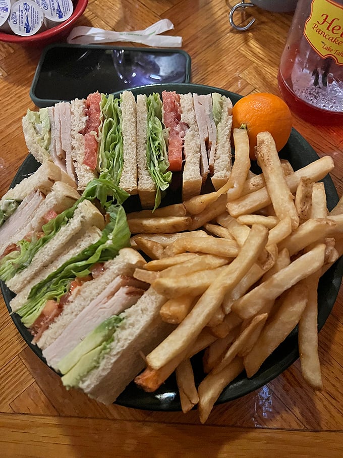 The club sandwich—proof that lunch at a breakfast joint isn't settling. Those perfectly stacked layers are architecture you can eat.
