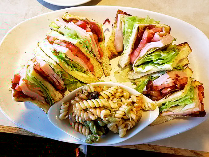 The club sandwich: stacked higher than your weekend plans and arranged with the precision of a small-scale engineering project.