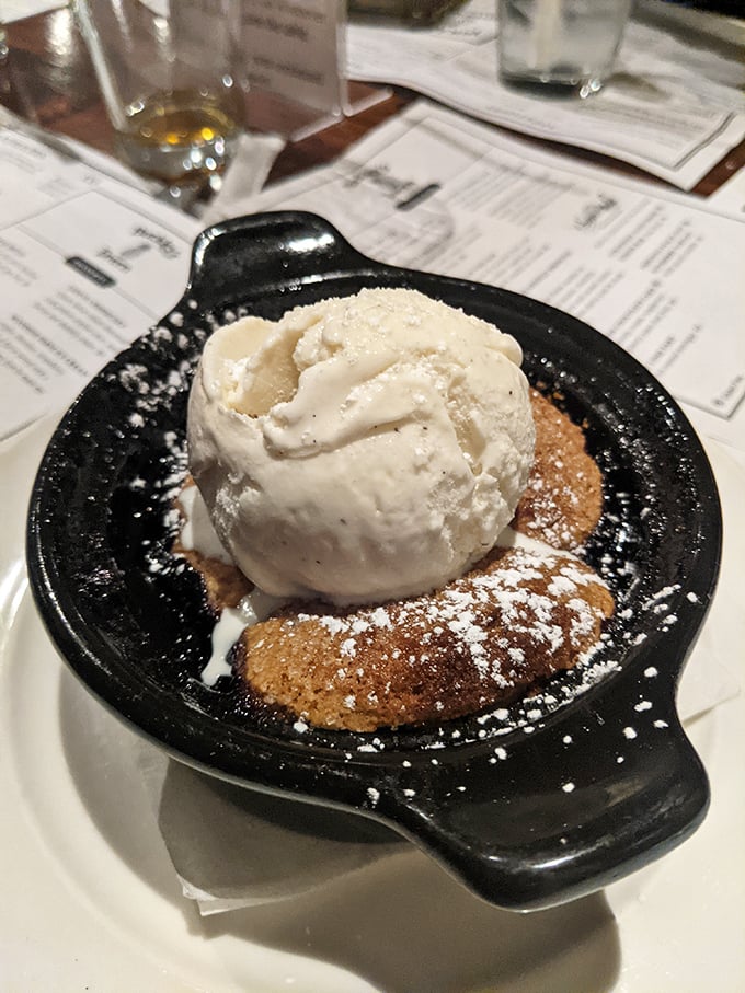 A warm cobbler topped with vanilla ice cream – the kind of dessert that makes you consider ordering a second before finishing the first.