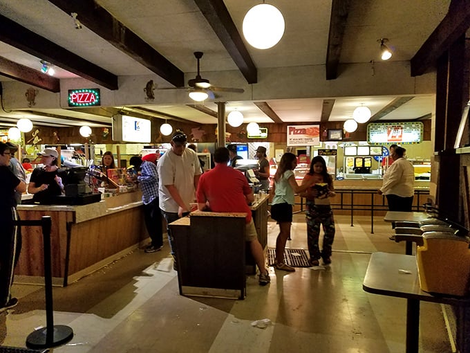 The beating heart of any drive-in—where teenagers earn first paychecks and families debate between pizza and hot dogs before settling on both.