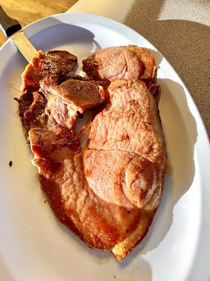 Country ham that's lived a full life of flavor. This isn't some paper-thin deli slice—it's a proper slab of porcine pleasure.
