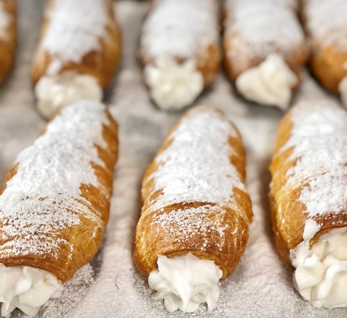 Cream horns that would make a unicorn jealous—delicate pastry shells filled with clouds of sweetened cream that disappear faster than your willpower.