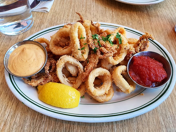 These calamari rings aren't those rubbery punishment circles from chain restaurants—they're tender morsels of oceanic delight with dipping sauces worth fighting over.