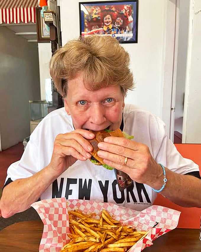 The satisfied smile of someone who just discovered their new favorite burger joint – priceless and contagious.
