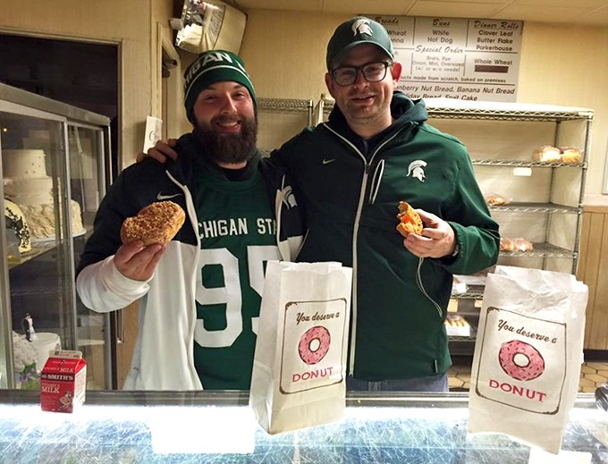 Sports rivalries disappear when donuts enter the equation – these Michigan State fans know that Schneider's treats transcend team loyalties.