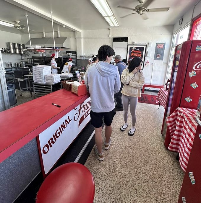 The line forms quickly at lunchtime – a diverse cross-section of Miami united by the universal language of exceptional square pizza.