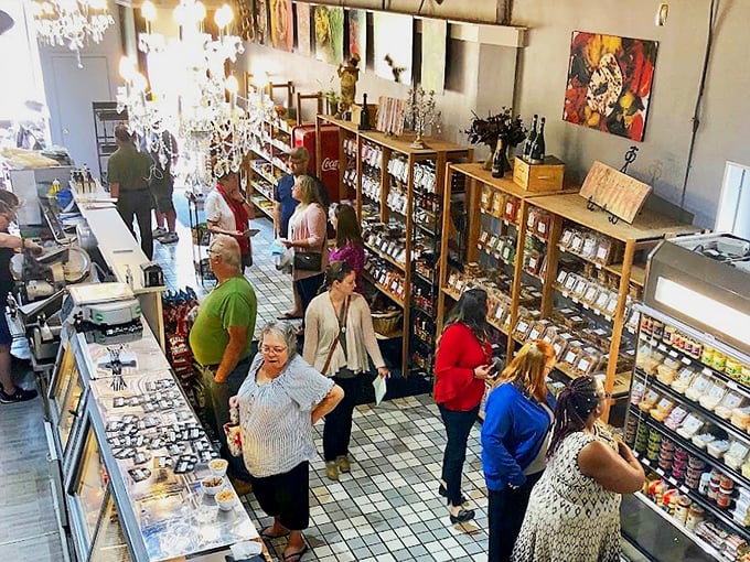 The true measure of a great food spot: locals lining up, patiently waiting their turn for deliciousness while eyeing the display case like it holds the secrets of the universe.