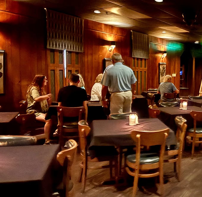 The warm wood-paneled dining room buzzes with conversation and anticipation—these diners know they're in for something special tonight.