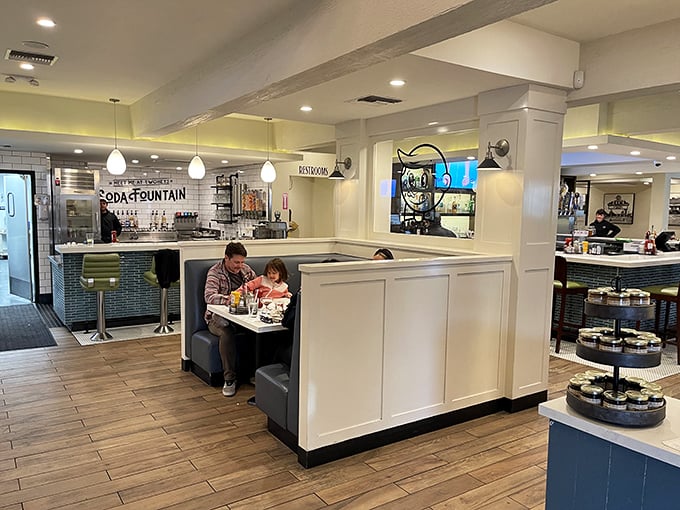 Family moments unfold in cozy booths while the nostalgic soda fountain beckons in the background – some traditions are worth preserving.
