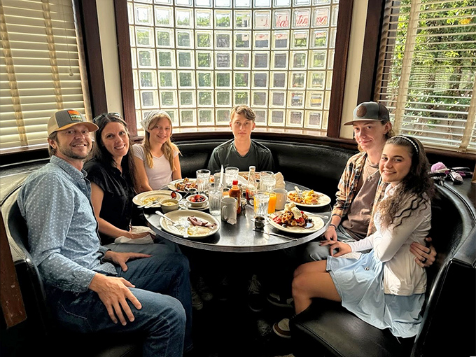 The curved booth by the window—prime real estate for family gatherings where memories are made between bites of breakfast and sips of coffee.