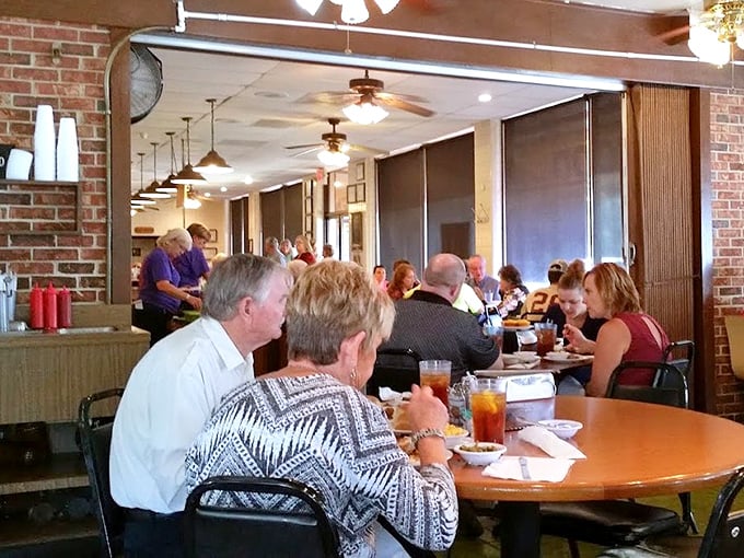 The dining room hums with the soundtrack of community—forks on plates, ice in glasses, and conversations that matter.