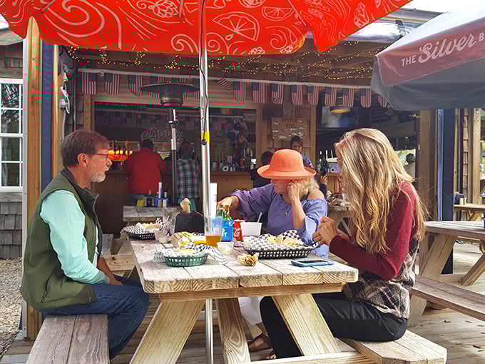 The outdoor picnic tables aren't just seating—they're community builders where strangers become friends over shared seafood platters.
