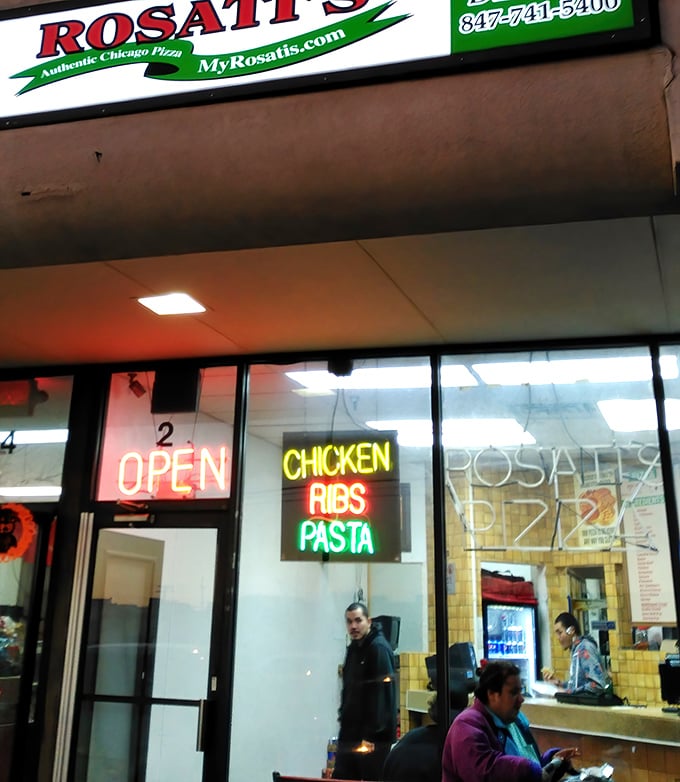 The neon glow of "OPEN" and "CHICKEN RIBS PASTA" serves as the bat signal for hungry Elgin residents.