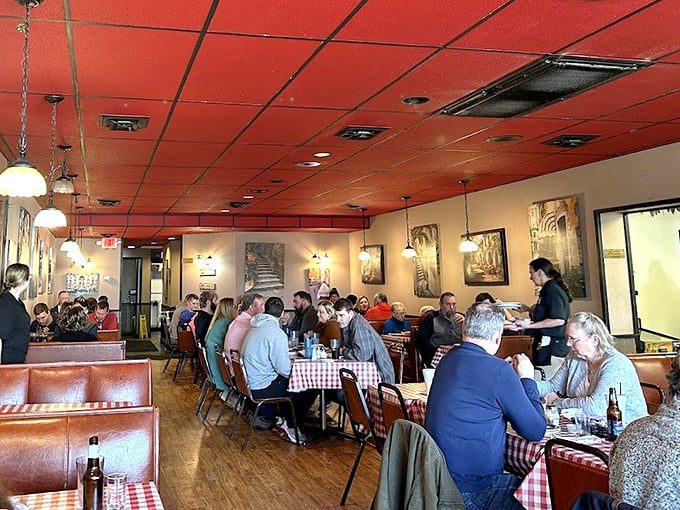 The dining room buzzes with conversation and clinking glasses. These aren't tourists – these are regulars who measure their lives in Giovanni's meals.