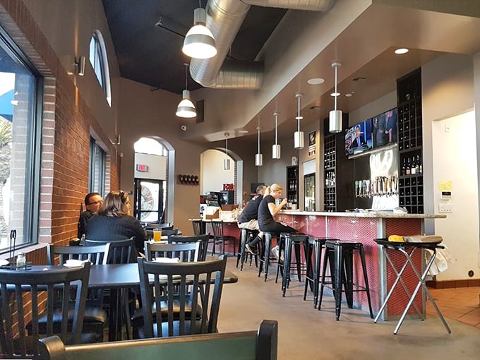 The bar area where strangers become friends over shared sauce stains. Nothing builds community quite like collectively abandoning proper eating etiquette.