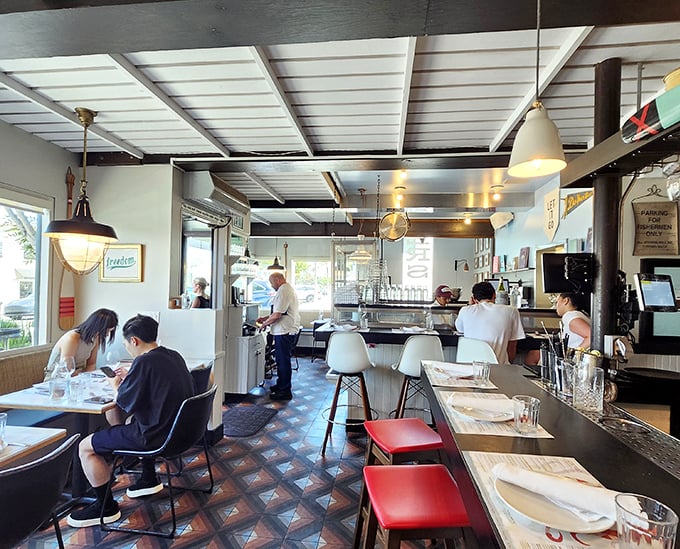 The dining room buzzes with the energy of people having exactly the meal they hoped for. Notice the perfectly spaced tables—they understand personal space here.