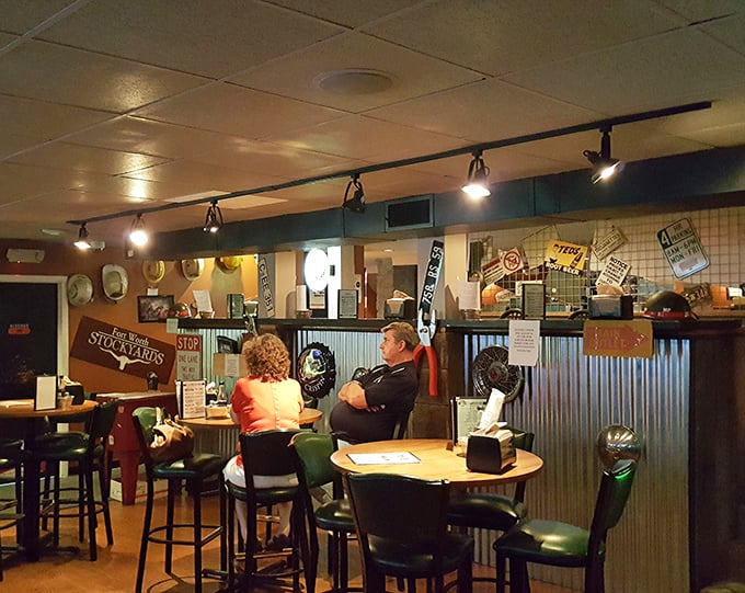 The high-top tables and corrugated metal backdrop create that perfect "local joint" atmosphere where strangers become friends over shared wing sauce recommendations.