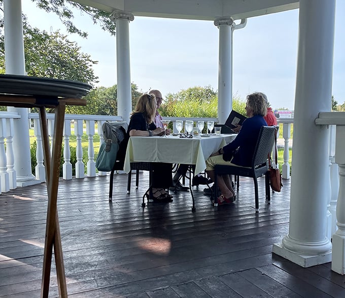 The wraparound porch dining experience—where fresh air and fine dining meet. Missouri countryside views complement every bite.