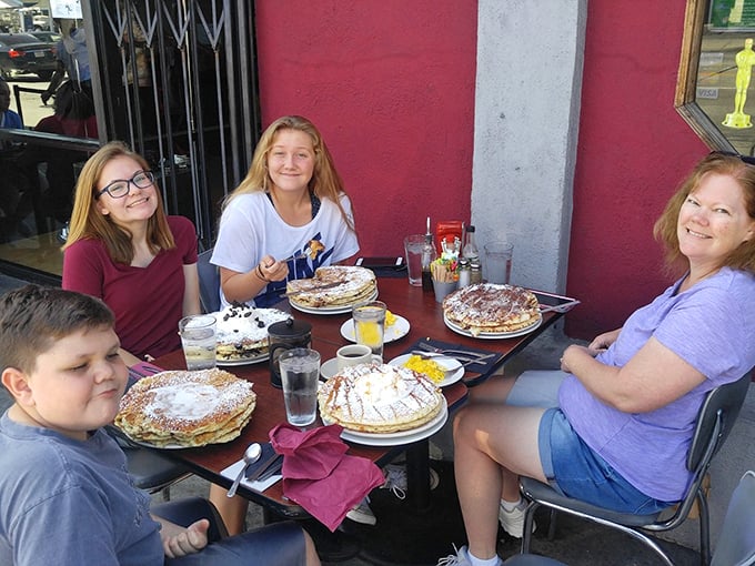 The universal expression on these diners' faces says it all: "We can't possibly finish these, but we're absolutely going to try."