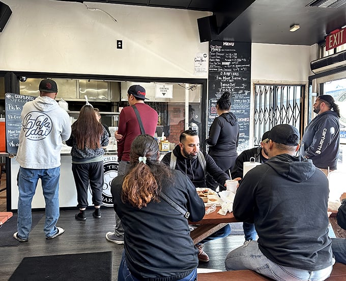 The line forms early—barbecue democracy in action where everyone waits their turn for a taste of Texas in Southern California.