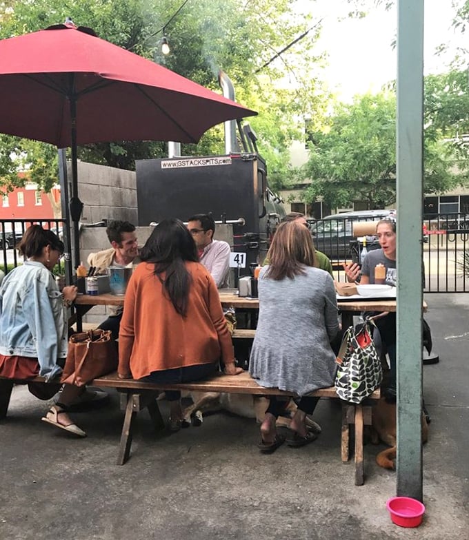 The outdoor seating area isn't just practical—it's where barbecue memories are made, sauce-stained napkins pile up, and friendships deepen.