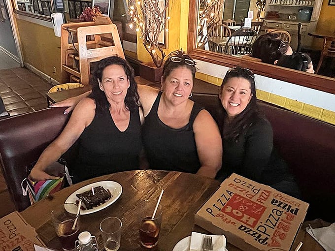 Happy diners caught in their natural habitat—the moment just before the food coma sets in but after the first heavenly bite.