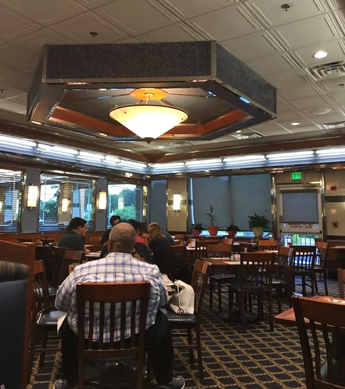 The dining room hums with the quiet energy of a community gathering place where everyone's story intersects over plates of comfort food.